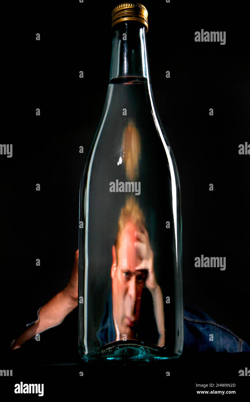 A depressed man tries to forget everything with a bottle of spirit. His ...