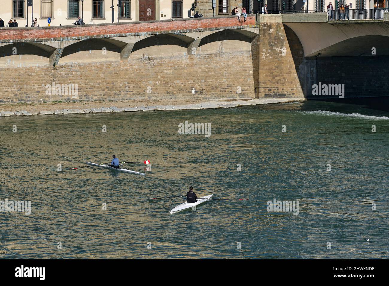 A couple of men rowing along the River Arno Stock Photo - Alamy