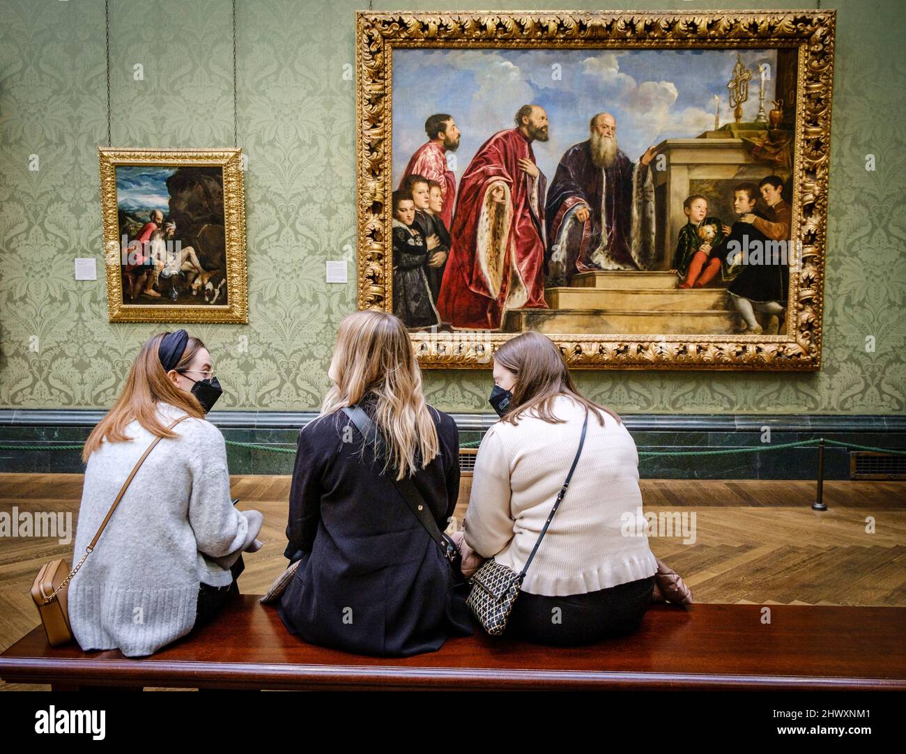 three women commenting on a painting Stock Photo - Alamy