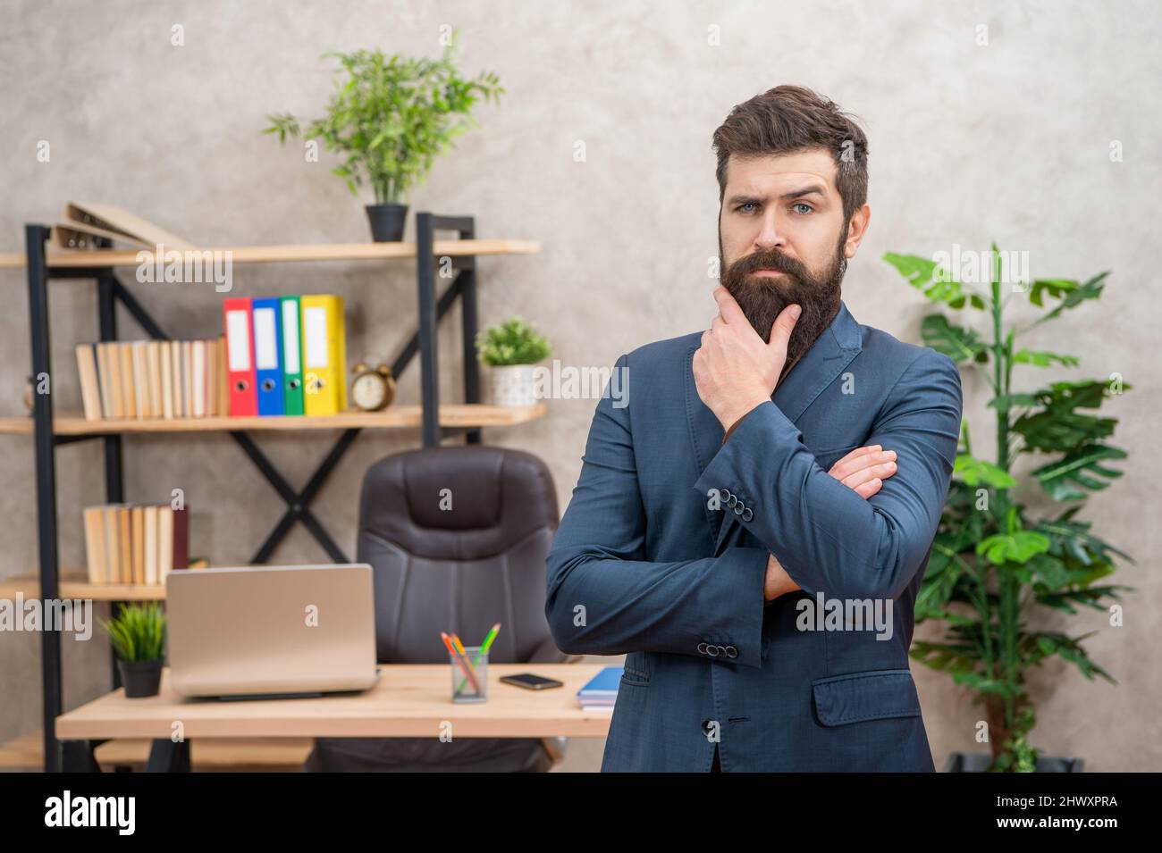 confident bearded boss wear suit in the office with copy space ...