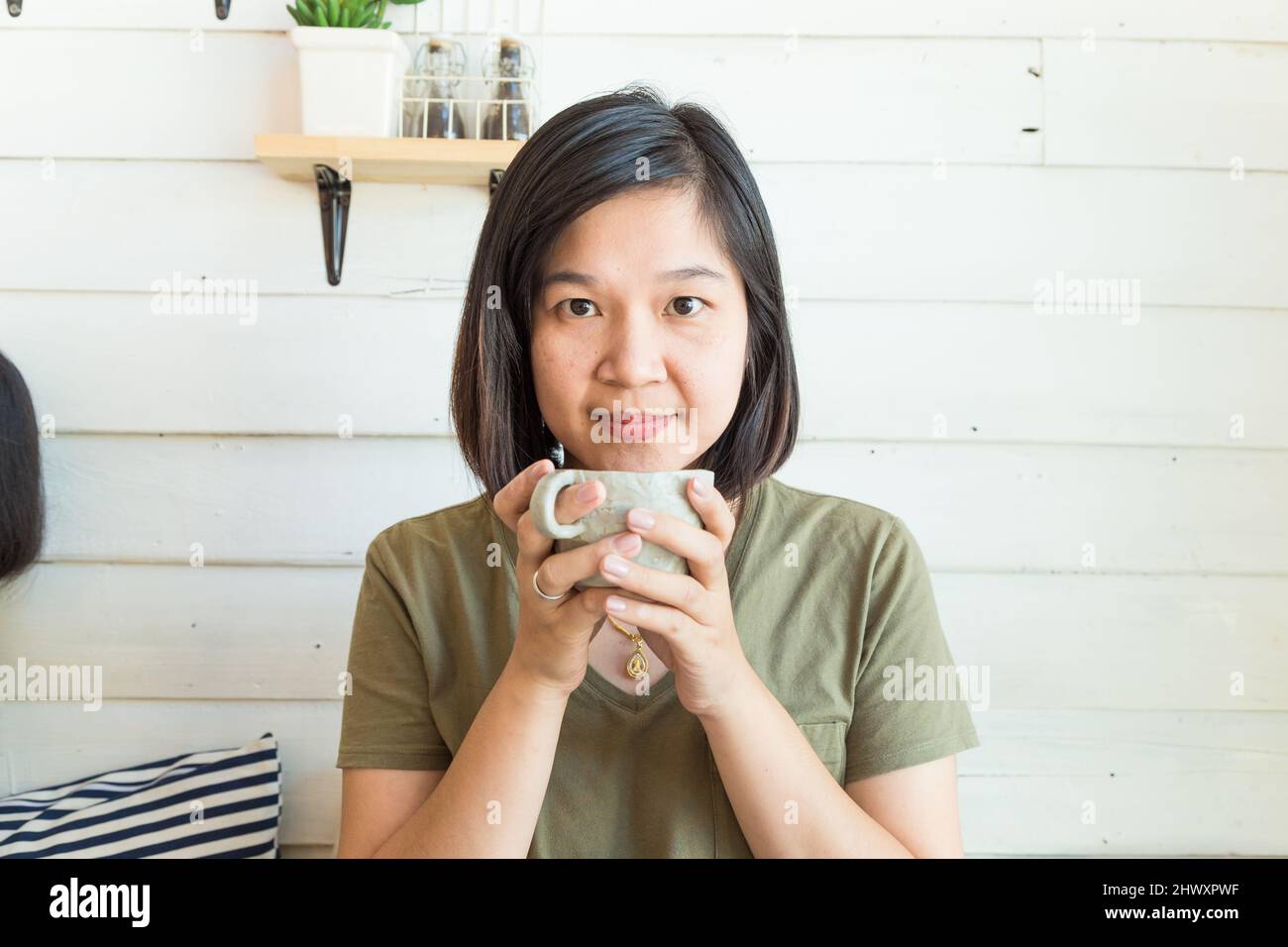 Beautiful business women drinking latte art coffee in white cafe Stock ...