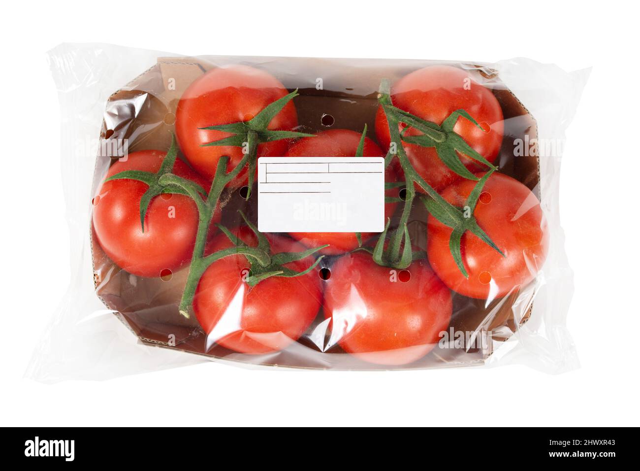 Freshly harvested tomatoes packaged and labeled on isolated white background Stock Photo - Alamy