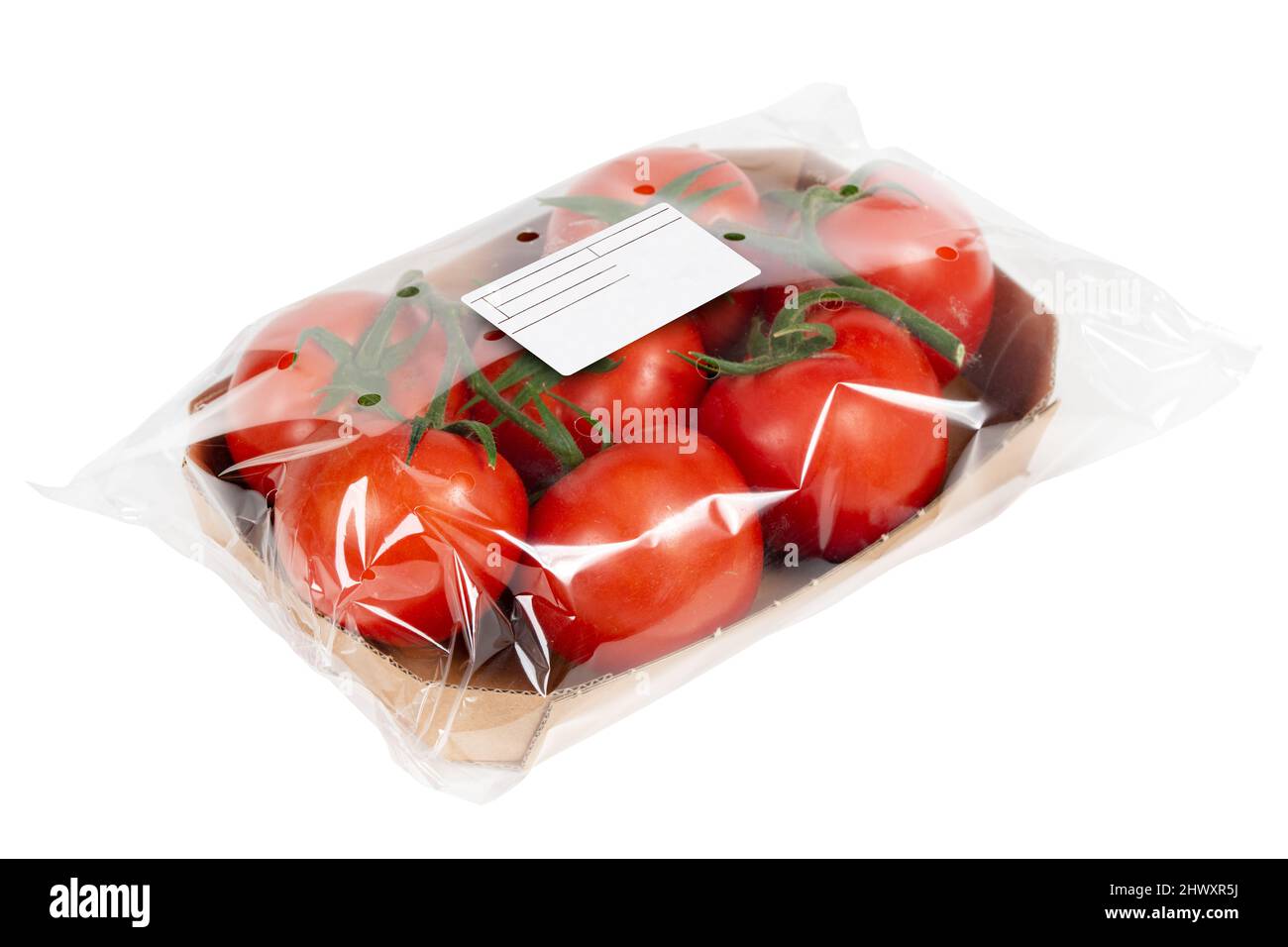 Freshly harvested tomatoes packaged and labeled on isolated white ...