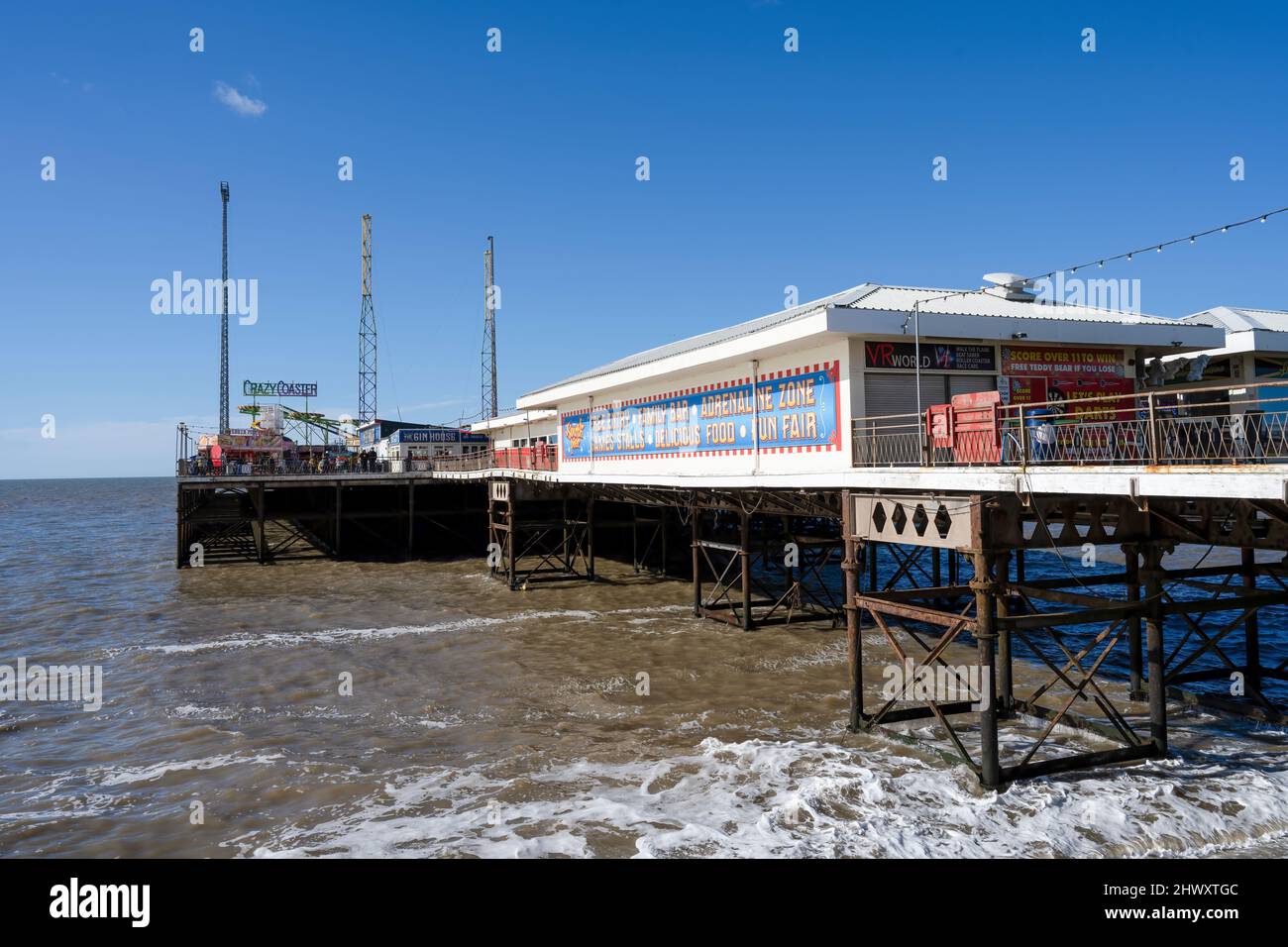 The sun shines in a blue sky over South Pier in Blackpool, Lancashire ...