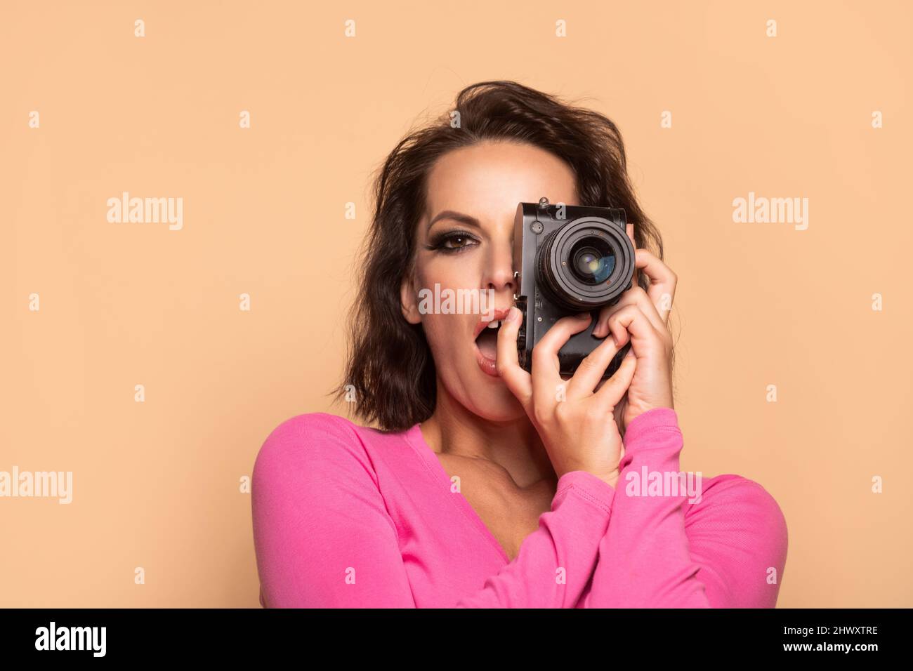 Portrait of excited girl photographer photographing with photo camera ...