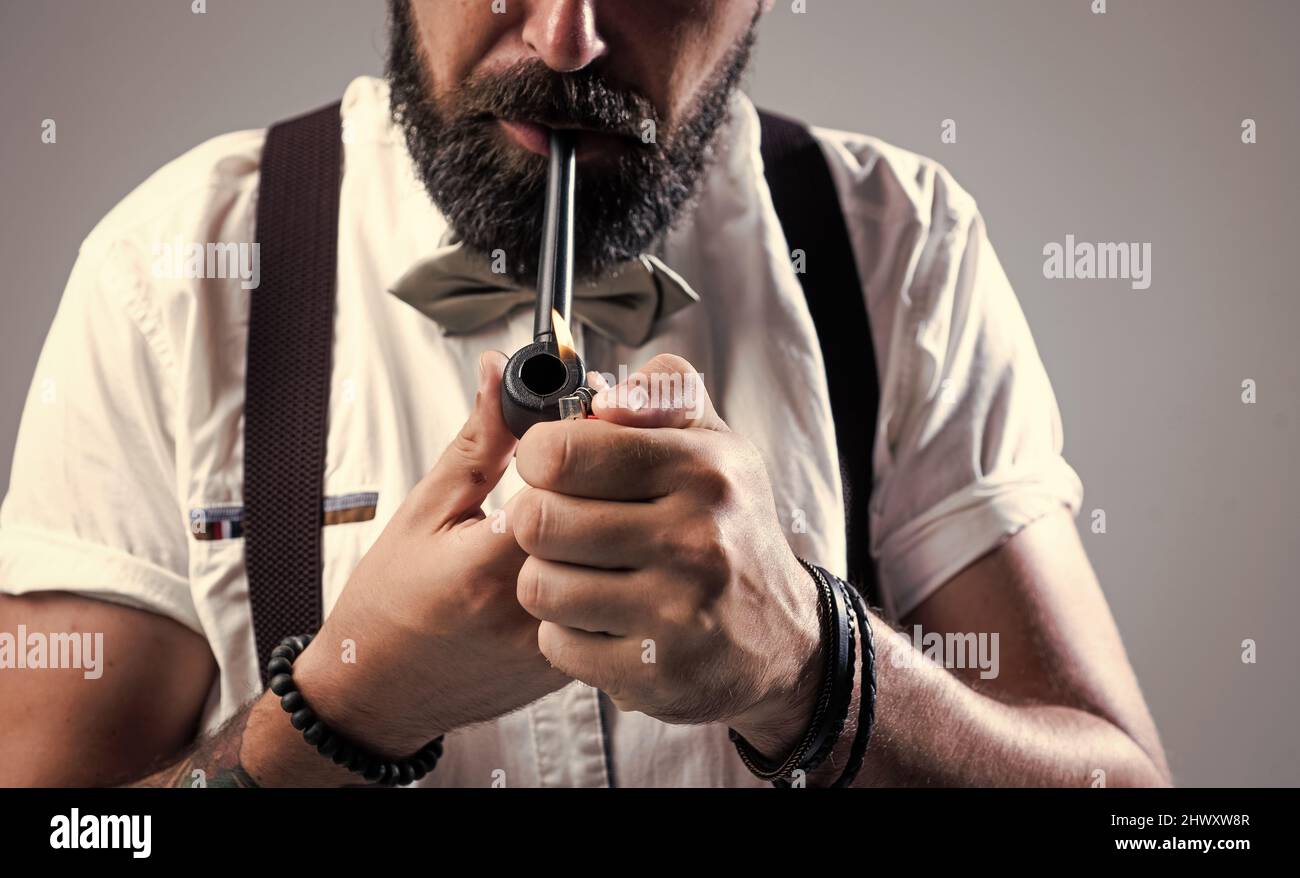 brutal bearded male with stylish look smoking pipe, smoker Stock Photo ...