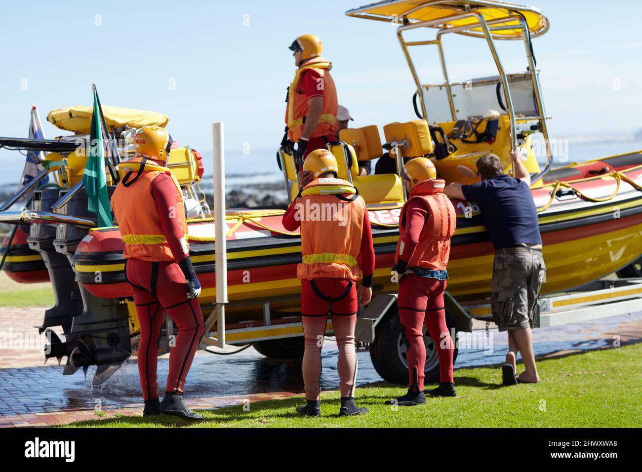 Getting ready to head out. Full length shot of a group of lifeguards ...