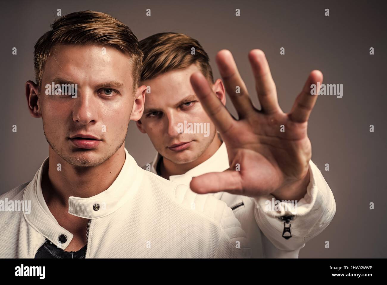 twin brothers men in white casual clothes look alike, identically Stock ...