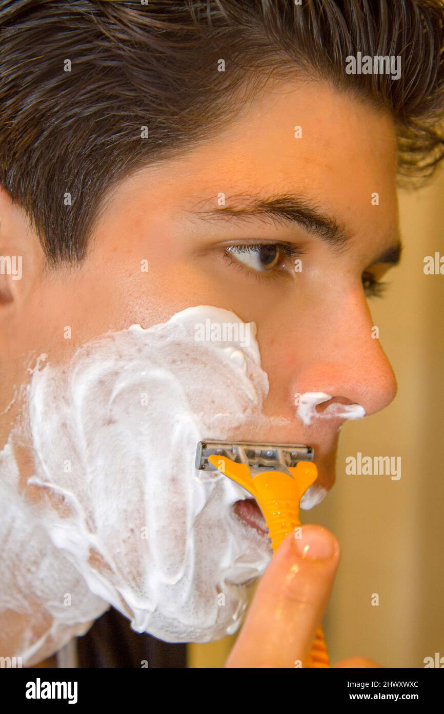 The picture shows a young man shaving. (MODEL RELEASED Stock Photo - Alamy
