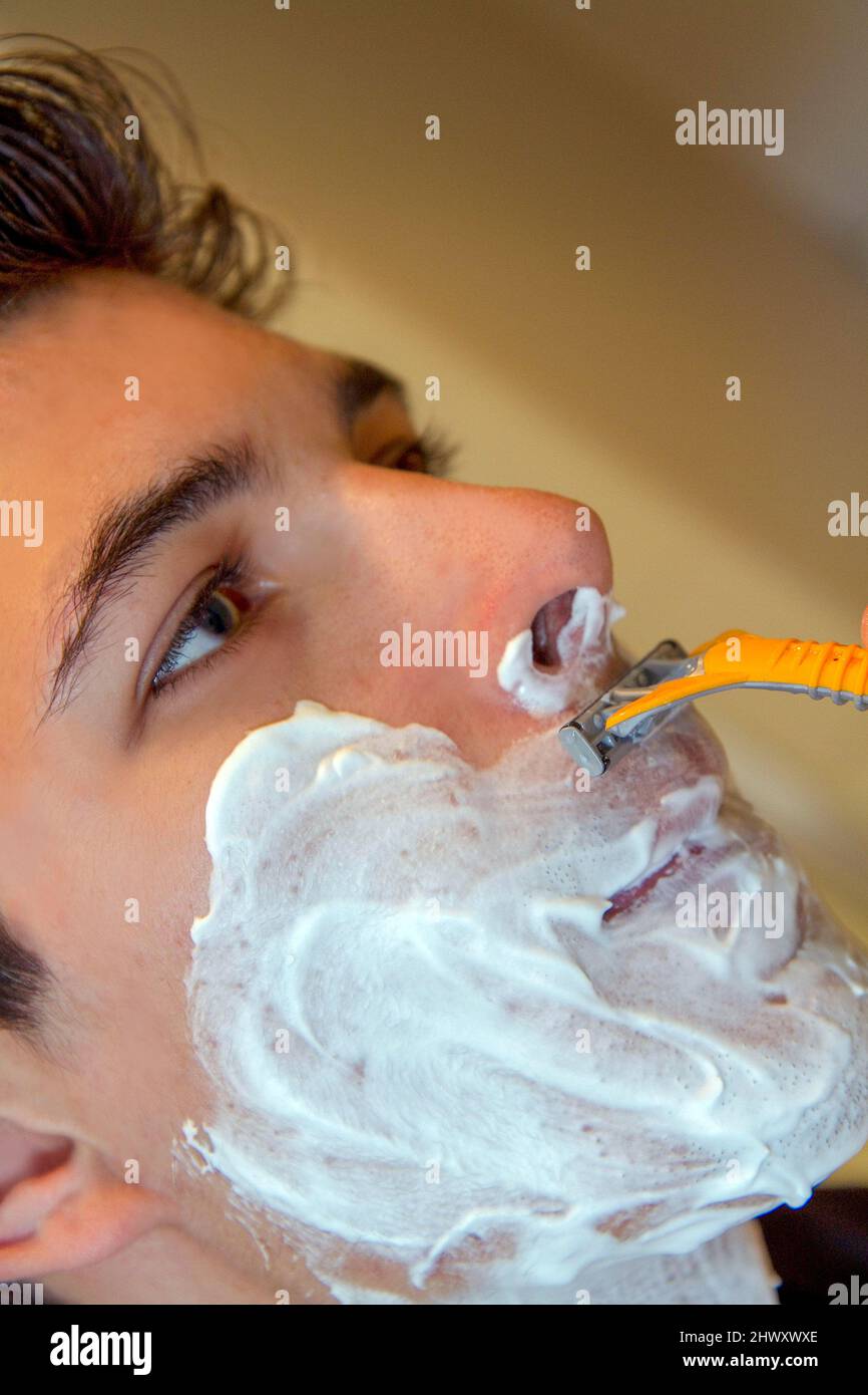 This picture shows a young man shaving (MODEL RELEASED Stock Photo - Alamy