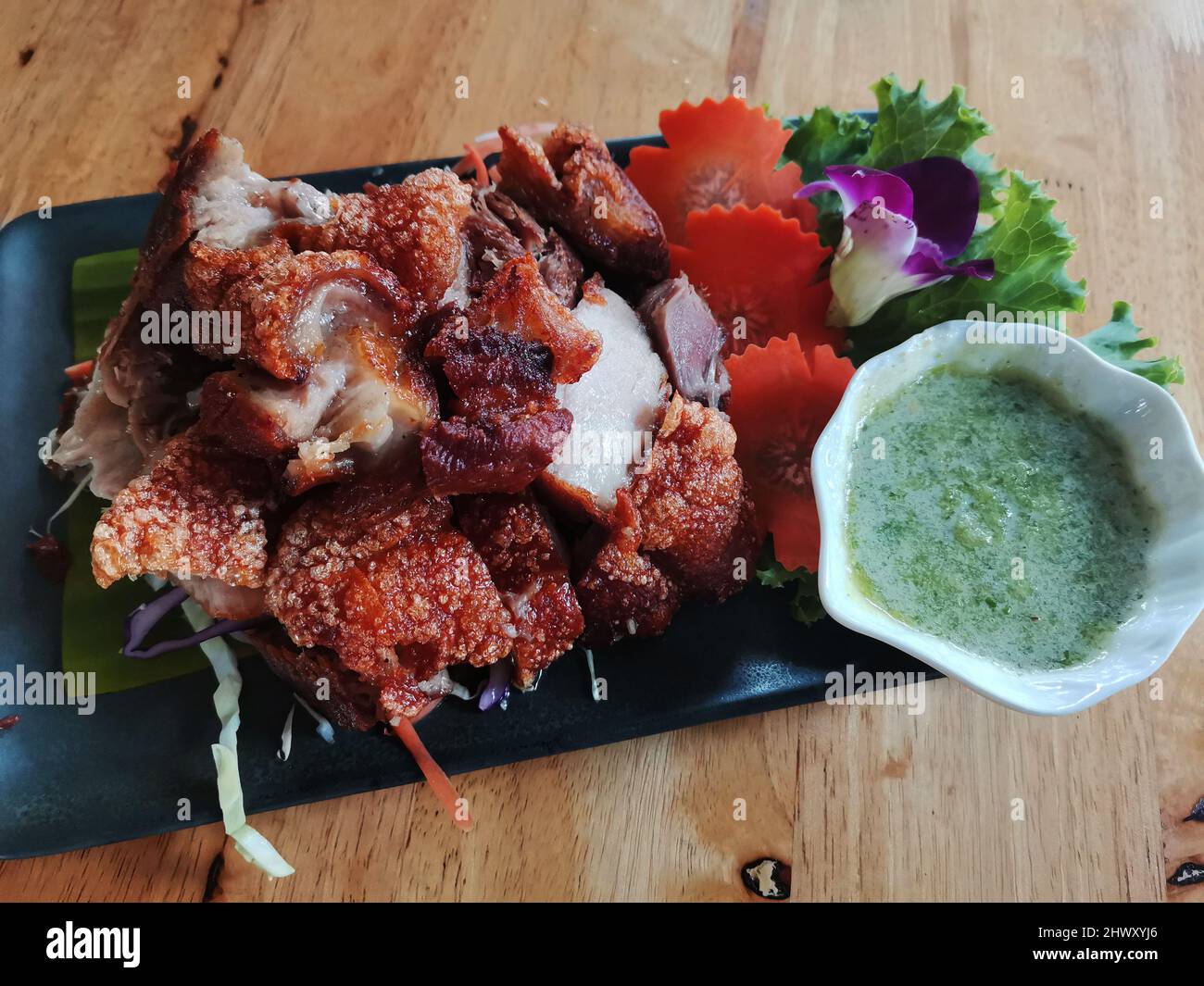 Thai chef cooking food fusion style cuisine roasted grilled fried leg ...