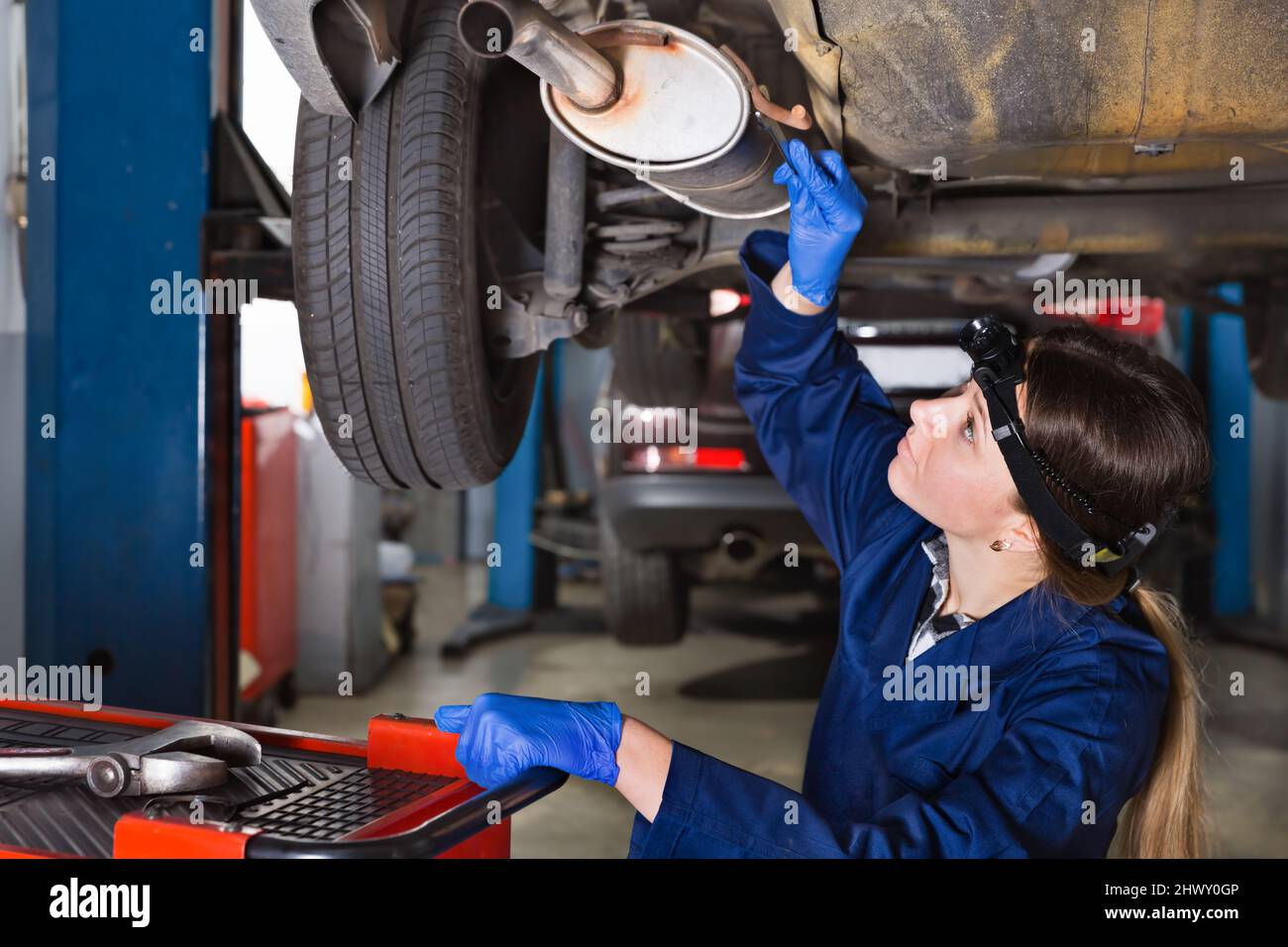 Female master is repairing car on her workplace Stock Photo - Alamy