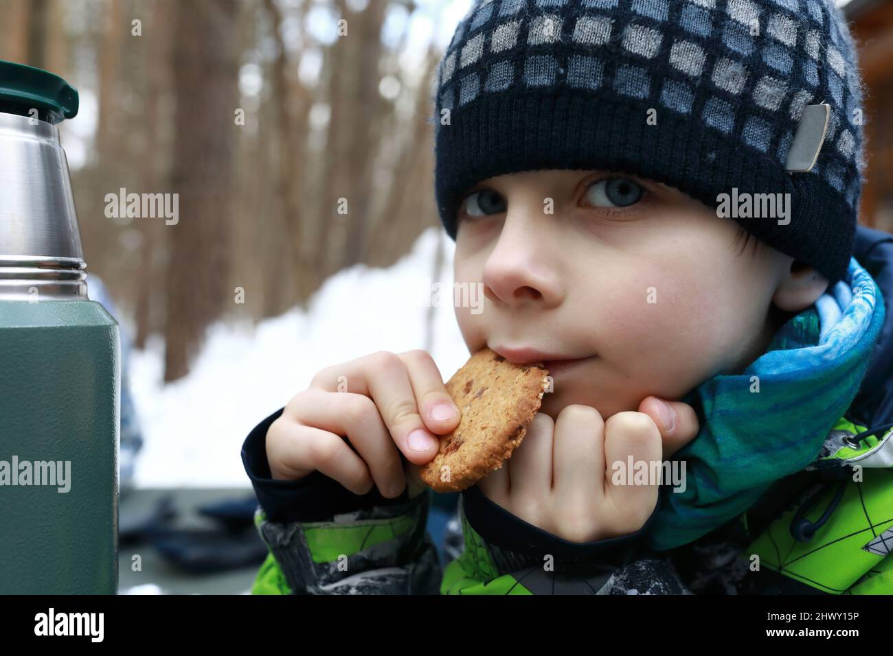 Portrait of child eating biscuit in winter cafe Stock Photo - Alamy