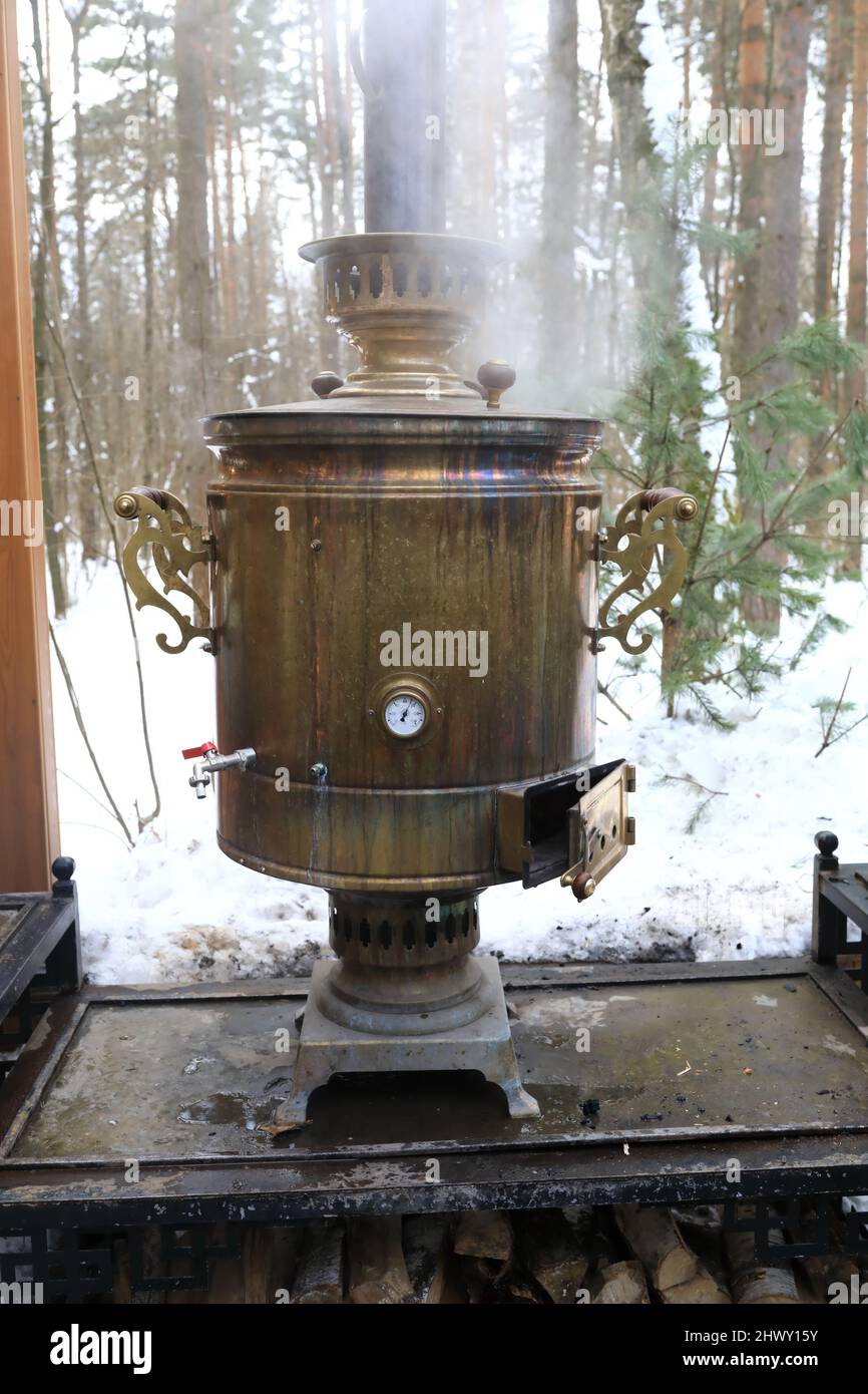 View of wood-burning samovar in park in winter Stock Photo - Alamy