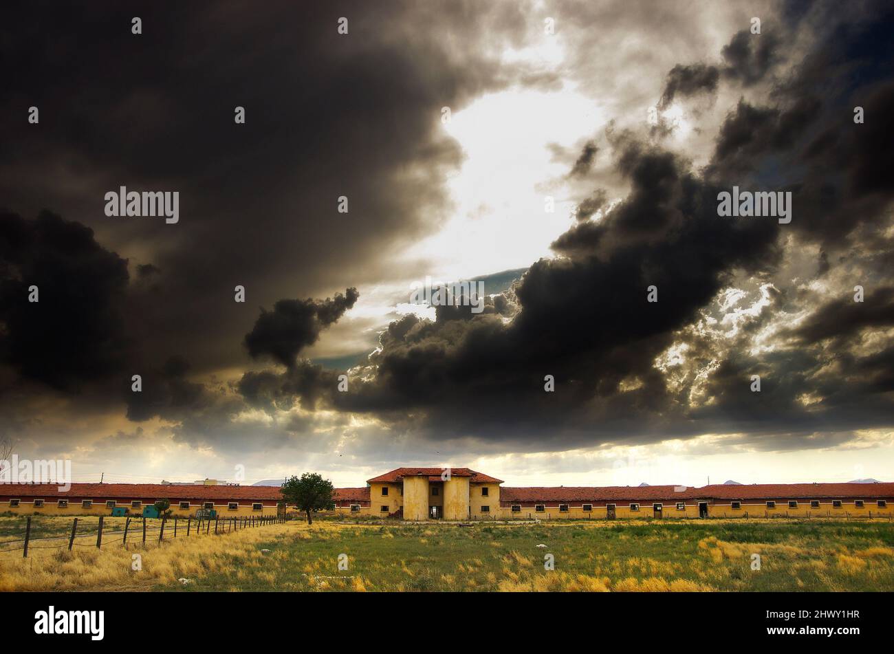 Old horse farm building with dark clouds. Old farmhouse scene Stock ...