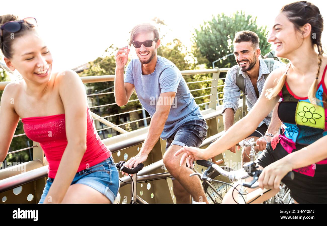 Young friends having fun riding bicycle at city park - Friendship life ...