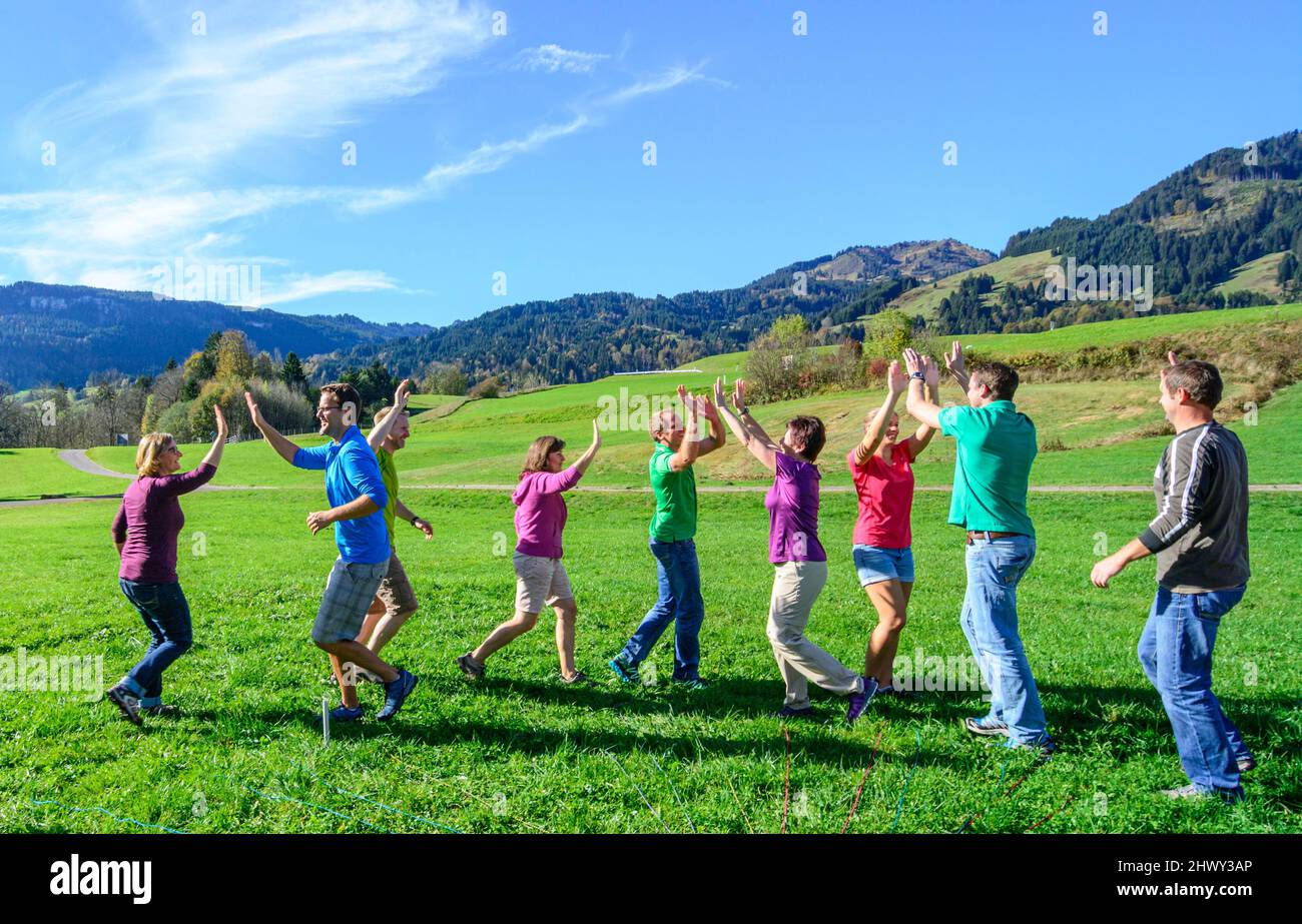 High Five after a successful teambuilding exercise Stock Photo - Alamy