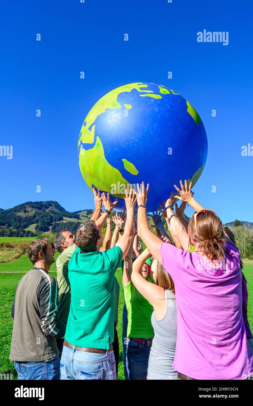 Carrying the world on hands Stock Photo - Alamy