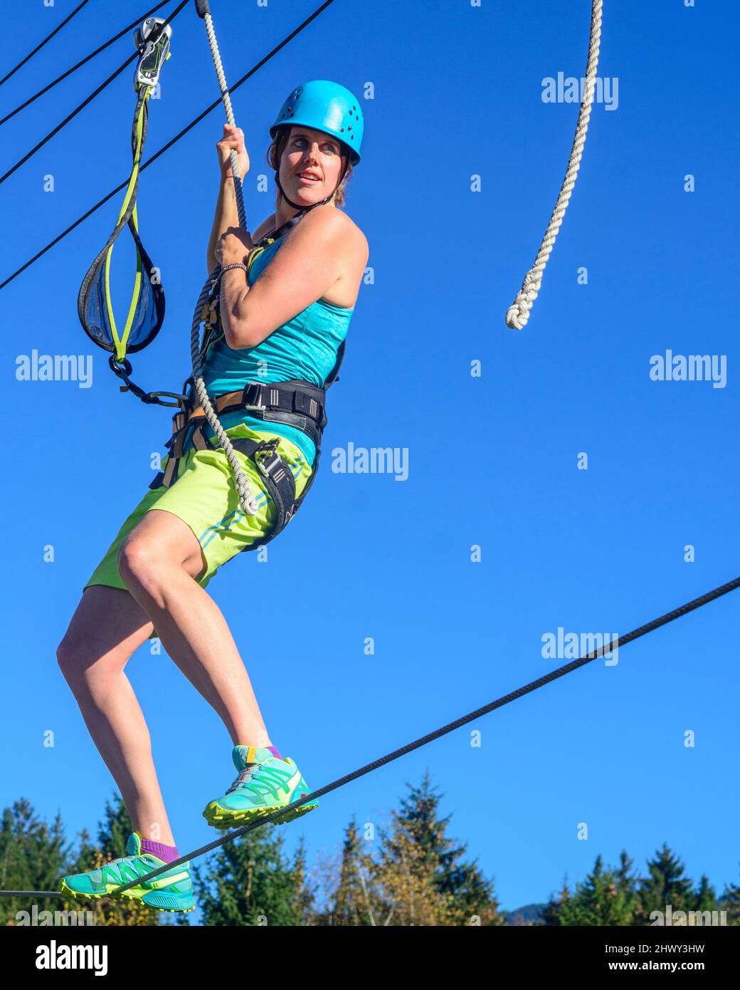 Balancing exercise in high ropes course Stock Photo - Alamy