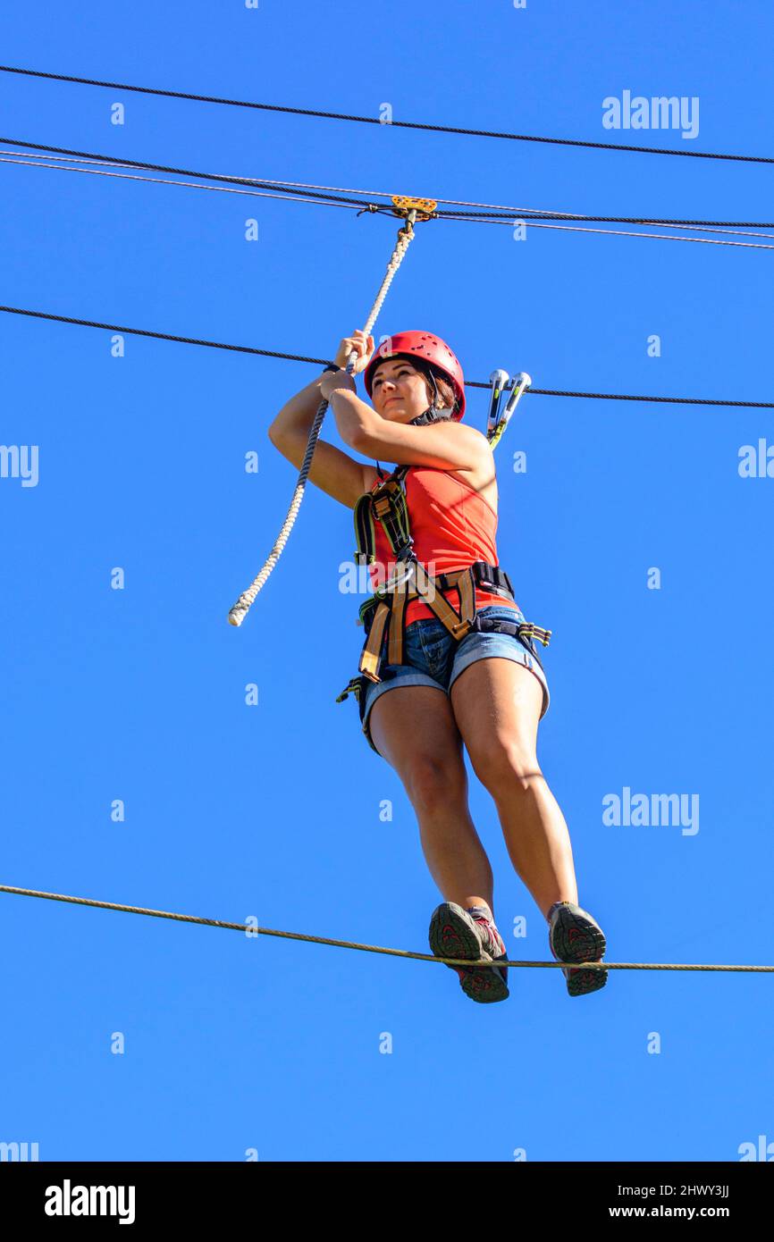 Balancing exercise in high ropes course Stock Photo - Alamy