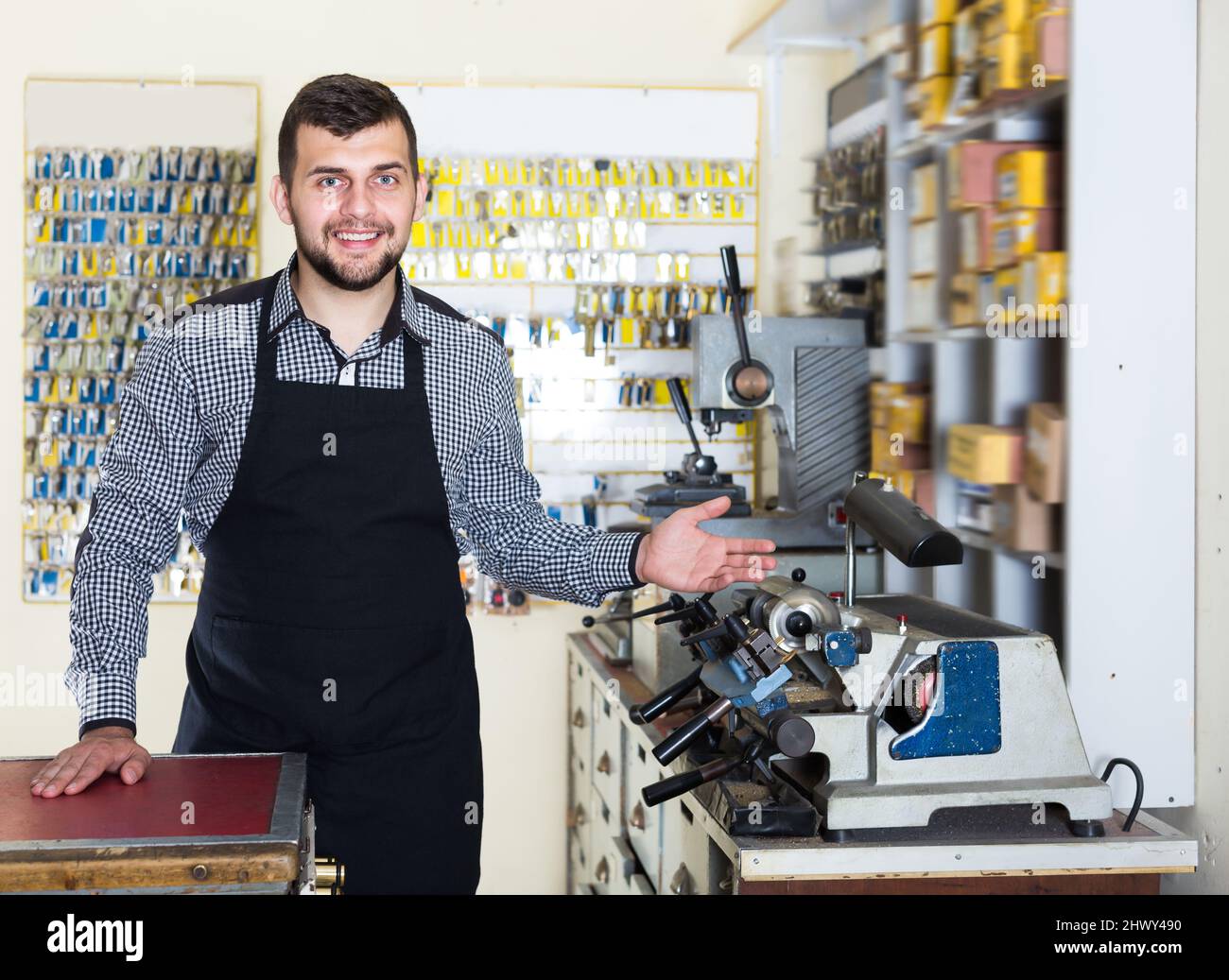 Worker demonstrating tools for making keys Stock Photo - Alamy
