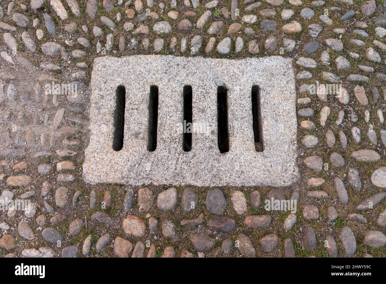 Ancient stone water drain in cobbled street, top view Stock Photo - Alamy