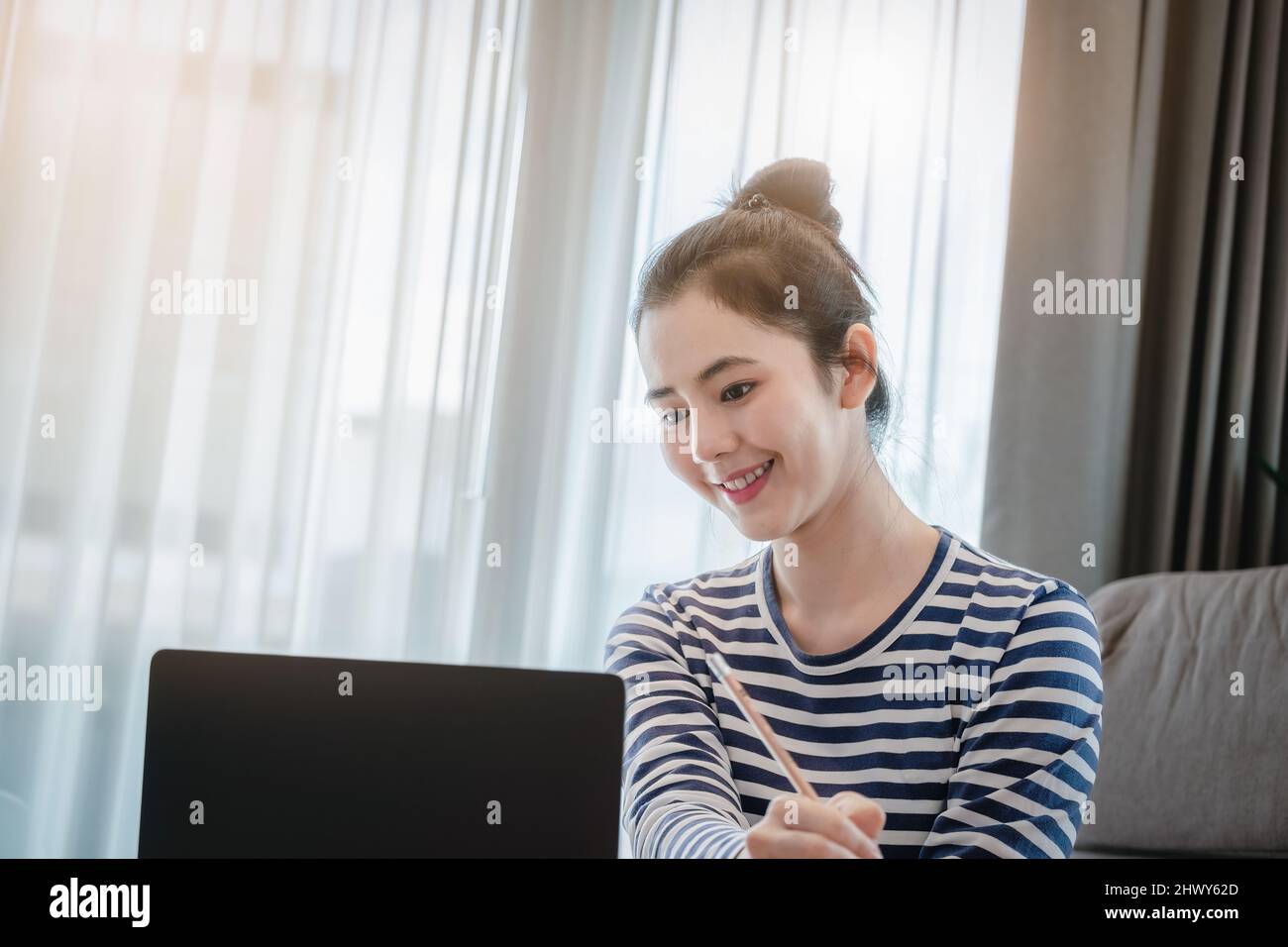 Online merchandising business idea, a beautiful girl is using a ...