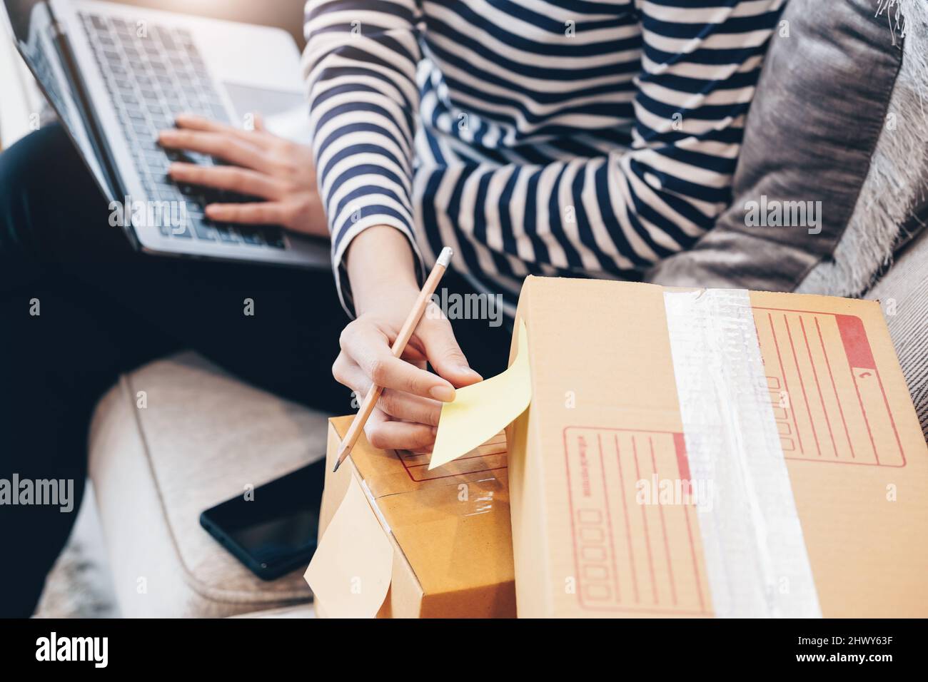 Online merchandising business idea, a beautiful girl is writing a ...