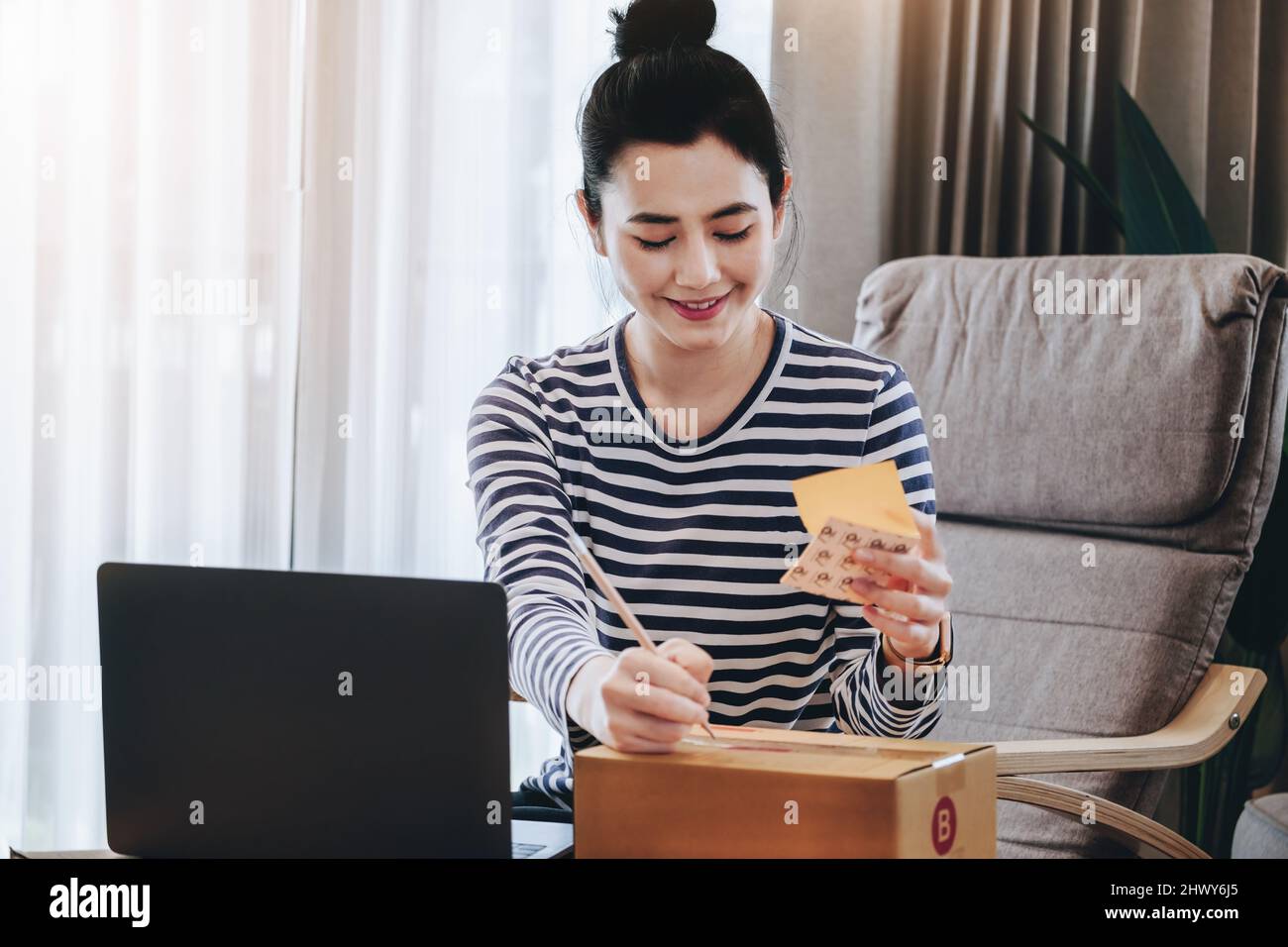 Online selling business idea, beautiful girl writing customer address ...
