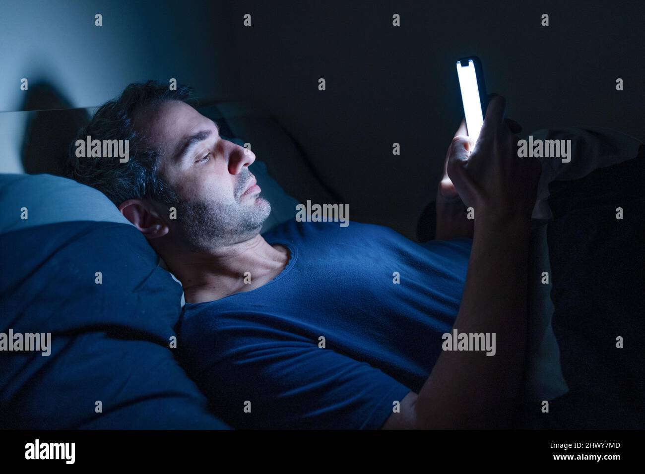 One man browsing on the mobile phone late at night Stock Photo - Alamy