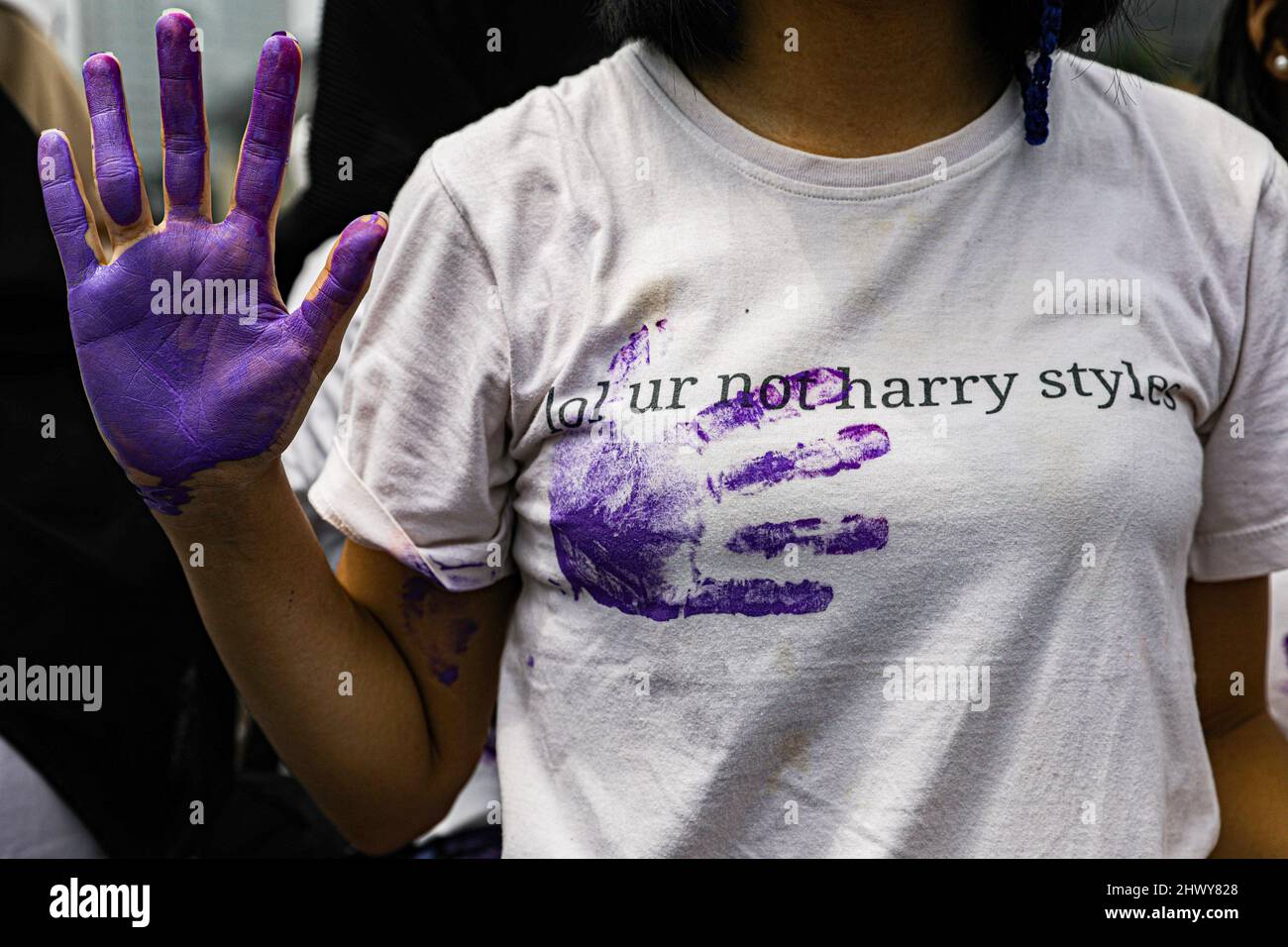 A woman seen with ink on her hand during the protest on International ...