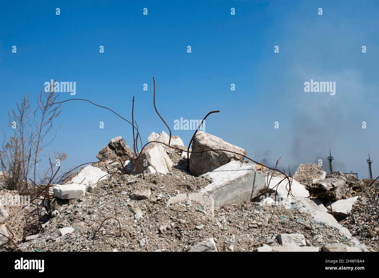 The rebar sticking up from piles of brick rubble, stone and concrete ...