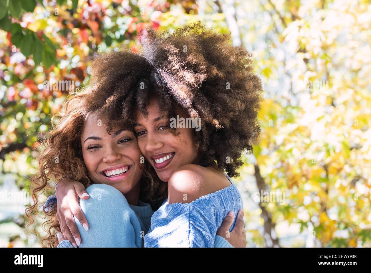 Closeup of two female afro american happy friends hugging each other ...