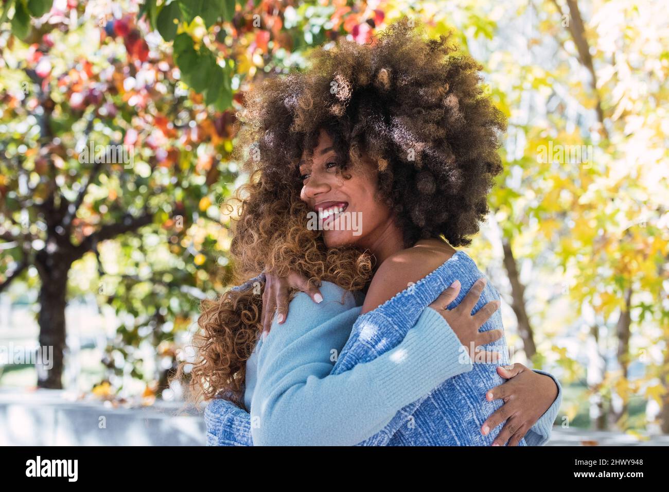 Portrait of two female afro american happy best friends hugging each ...