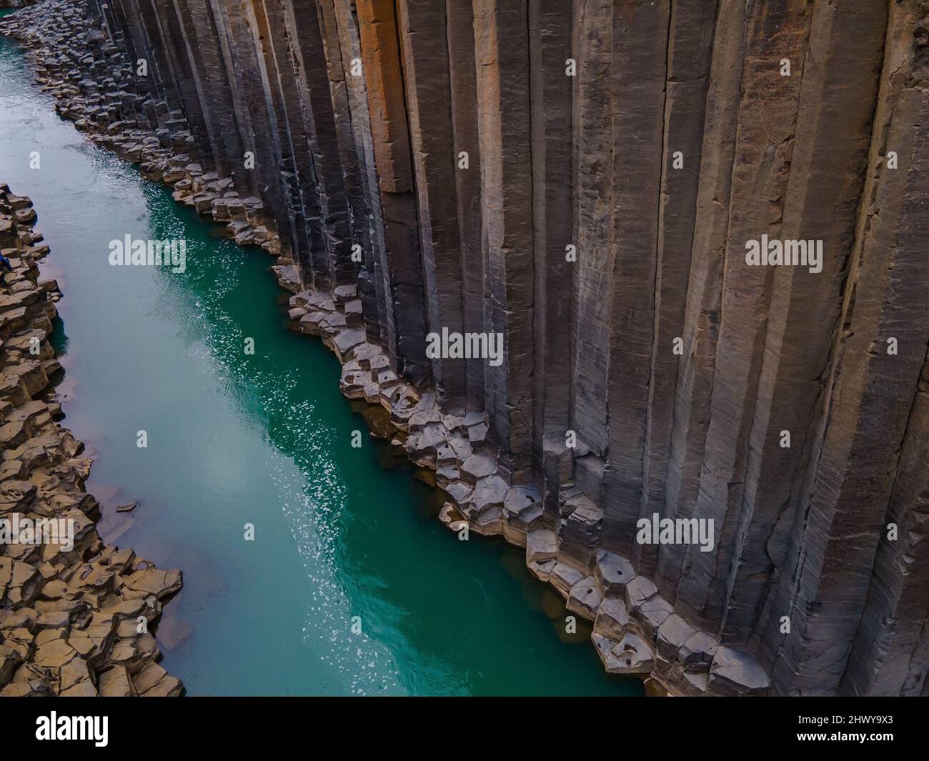 Beautiful aerial view of the studlagil canyon, and the largest number of basalt rock columns in ...