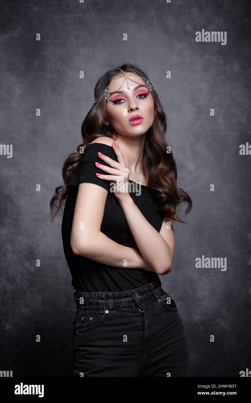 Beauty portrait of young woman on gray background. Brunette girl with ...