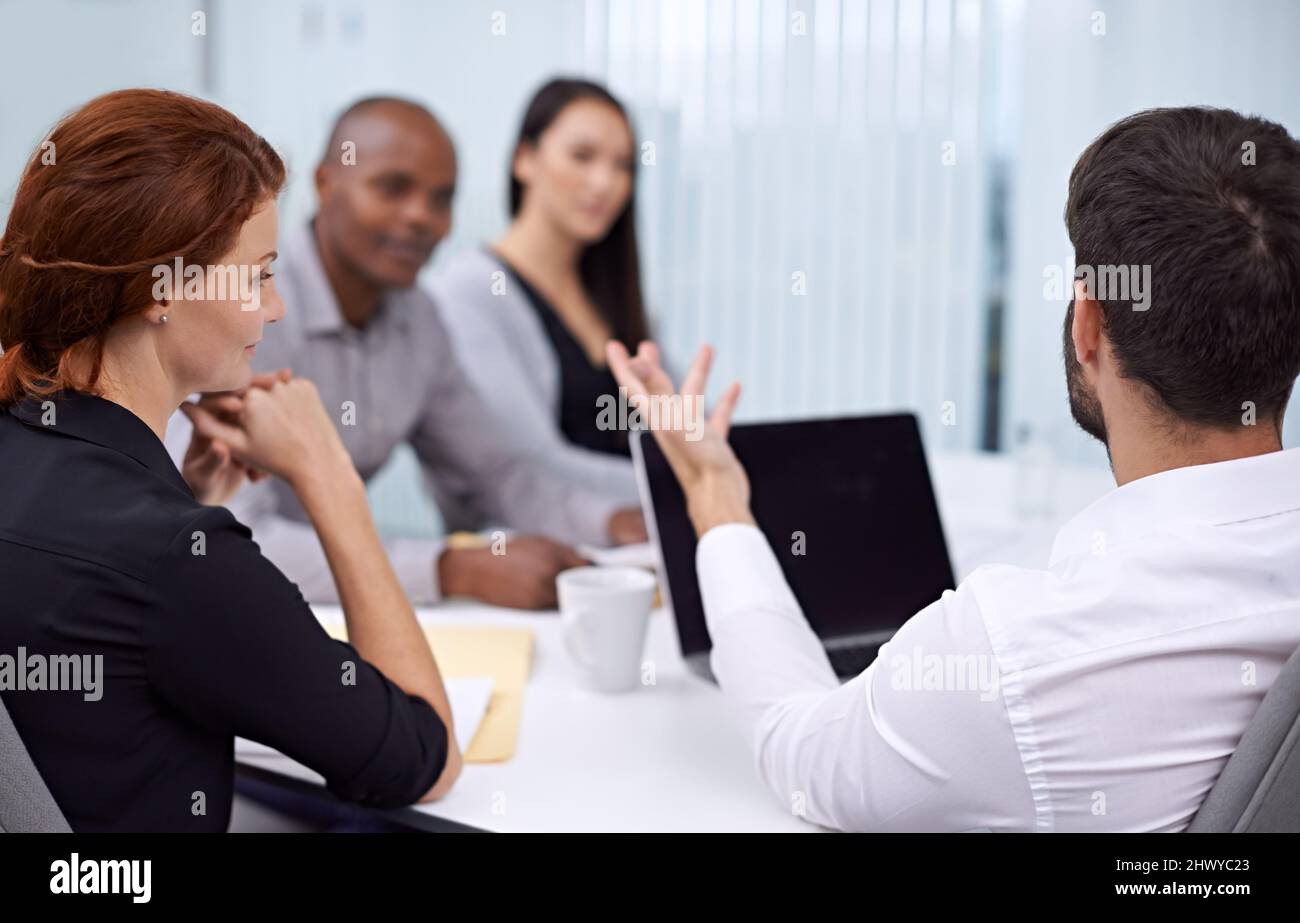 Lets talk numbers people. A group of coworkers having a meeting Stock ...