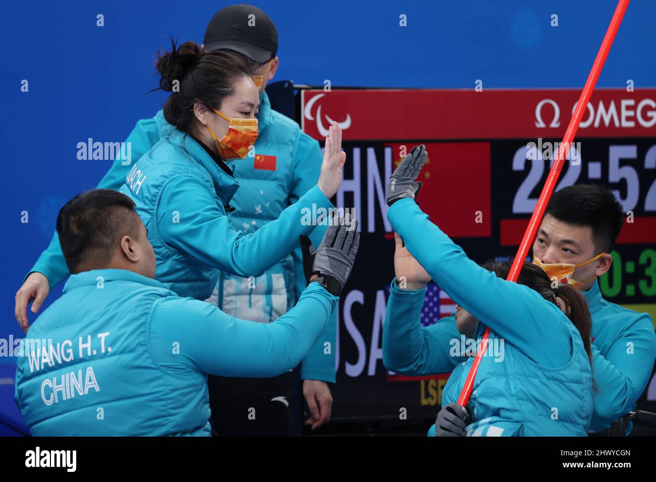 Beijing, China. 8th Mar, 2022. Yue Qingshuang (2nd L), coach of China ...
