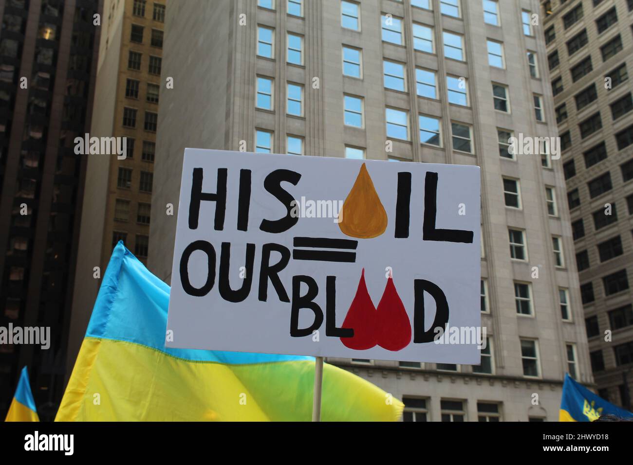 His Oil Our Blood protest sign with Ukrainian flag at Daley Center ...