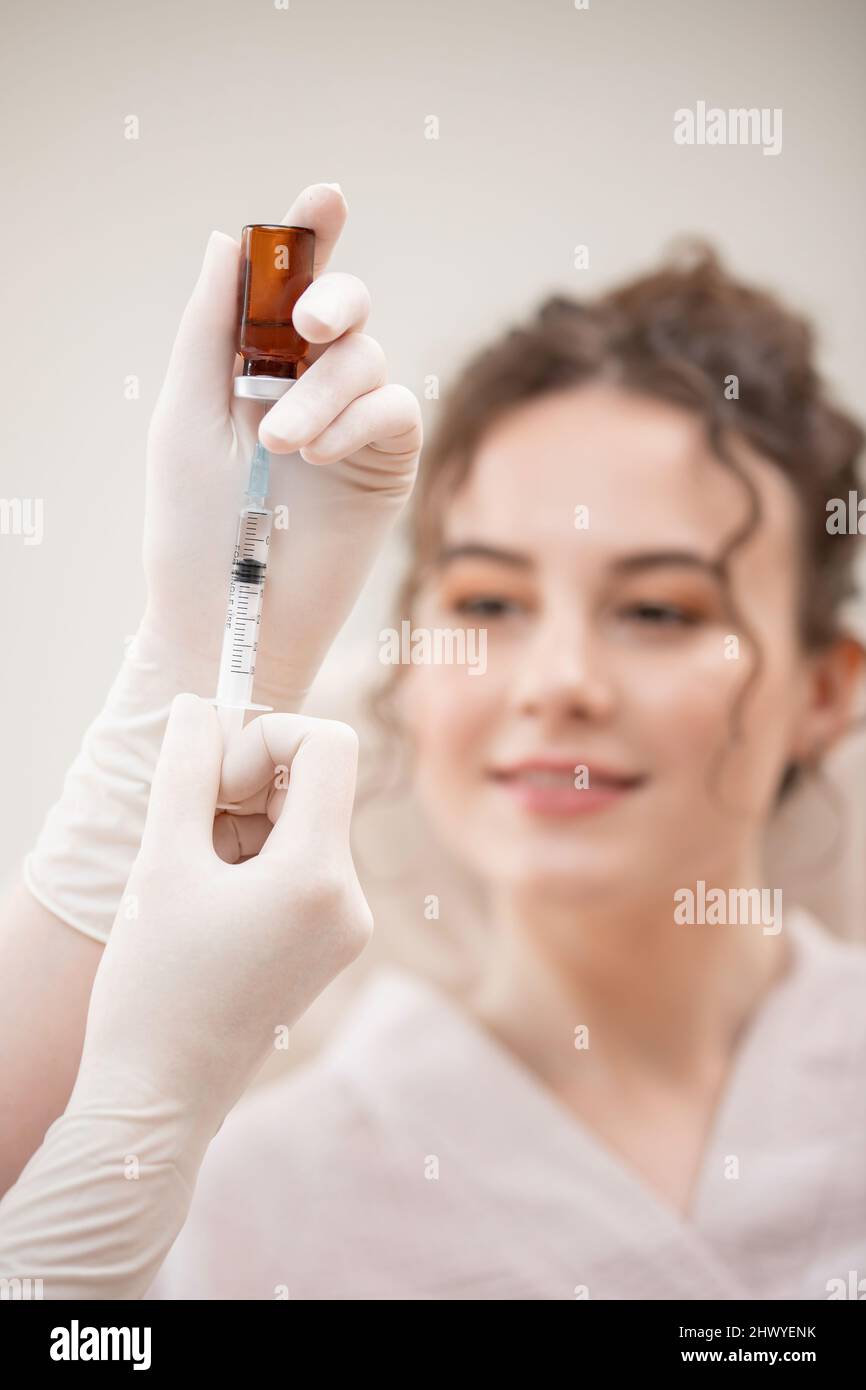 Doctor use syringe for filler injections for young woman. Beauty ...