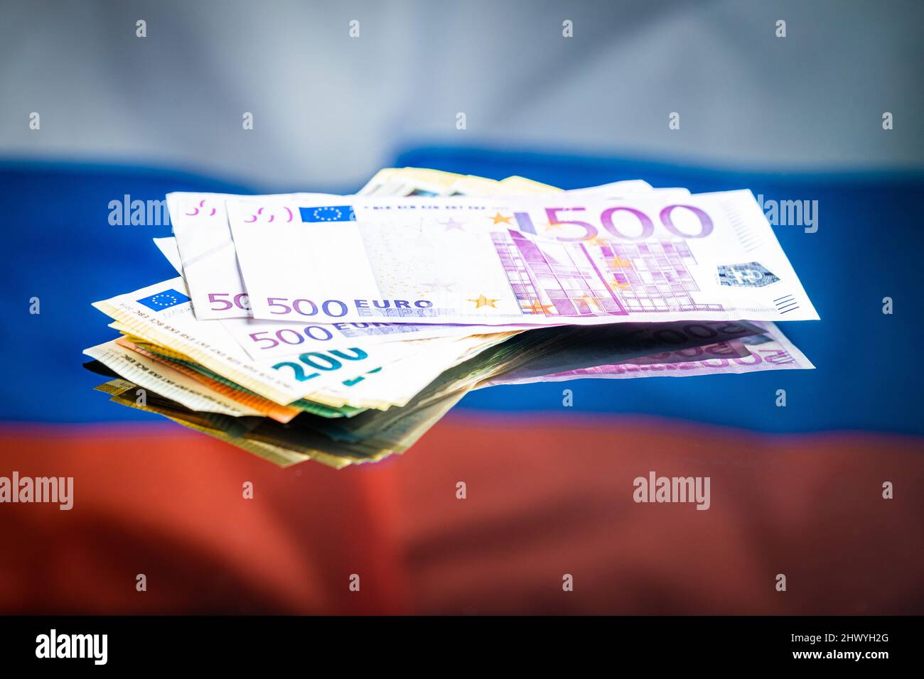 Euro banknotes in front of Russian flag. The paper European currency ...