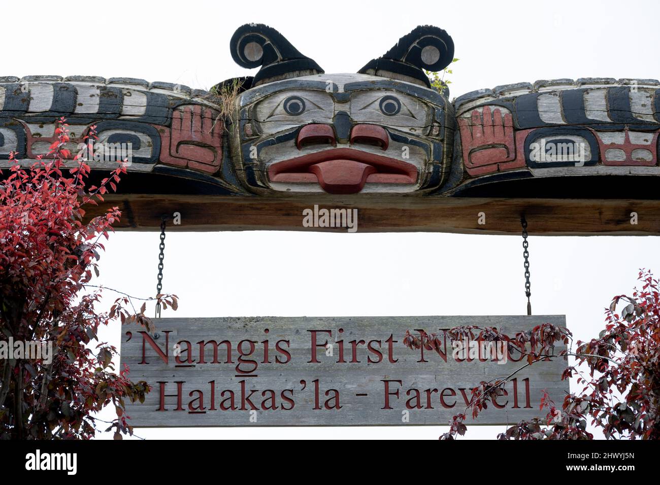 Namgis First Nations sign below an Indigenous carving on Alert Bay on ...