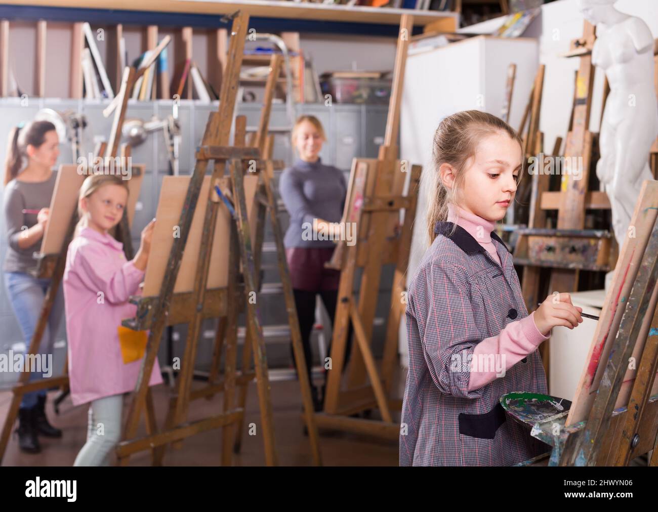 schoolgirls diligently training their painting skills during class at ...