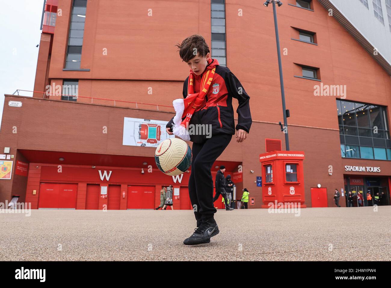 A young Liverpool fan doing kick-ups outside Anfield Stock Photo - Alamy