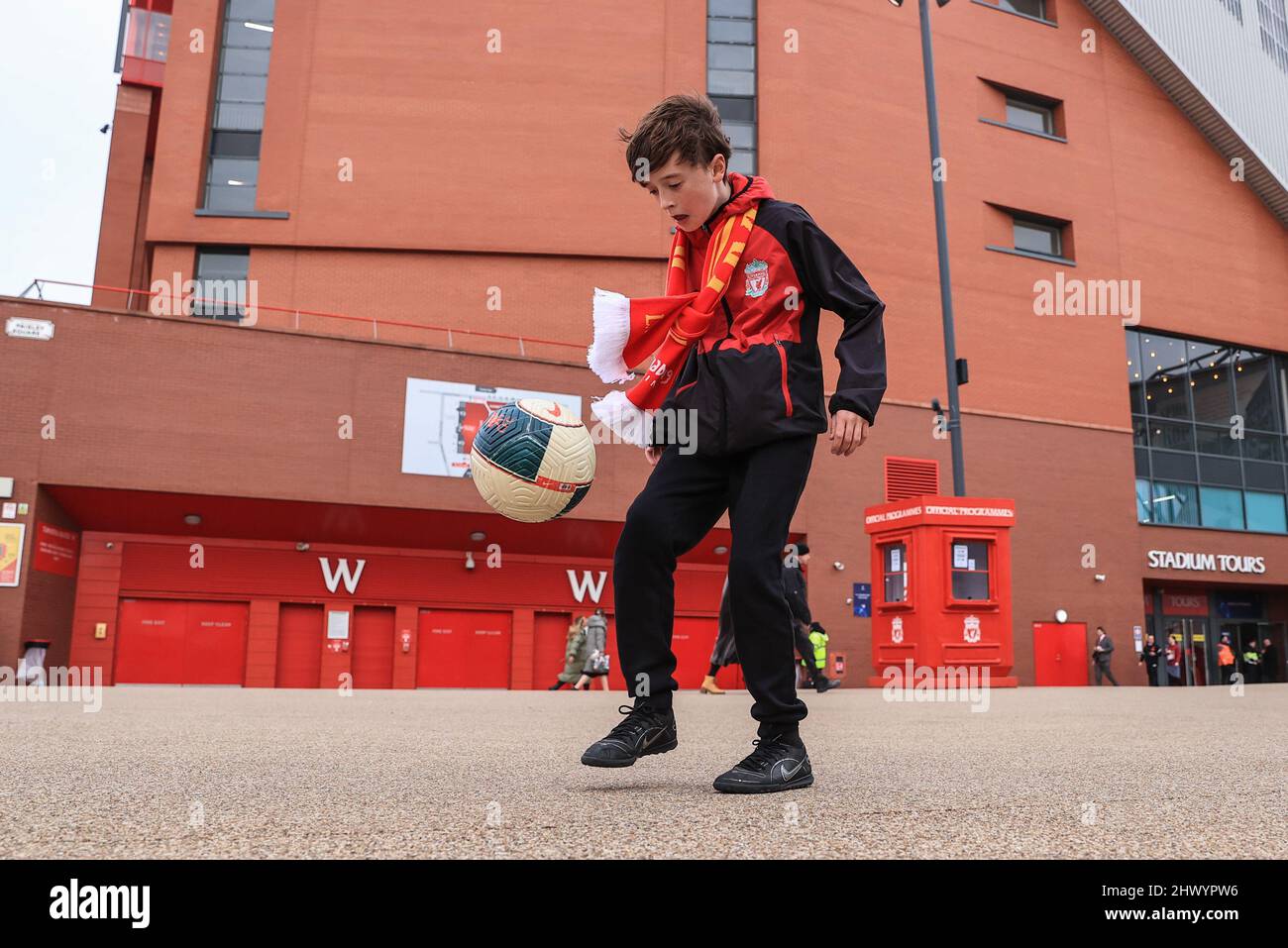 A young Liverpool fan doing kick-ups outside Anfield Stock Photo - Alamy