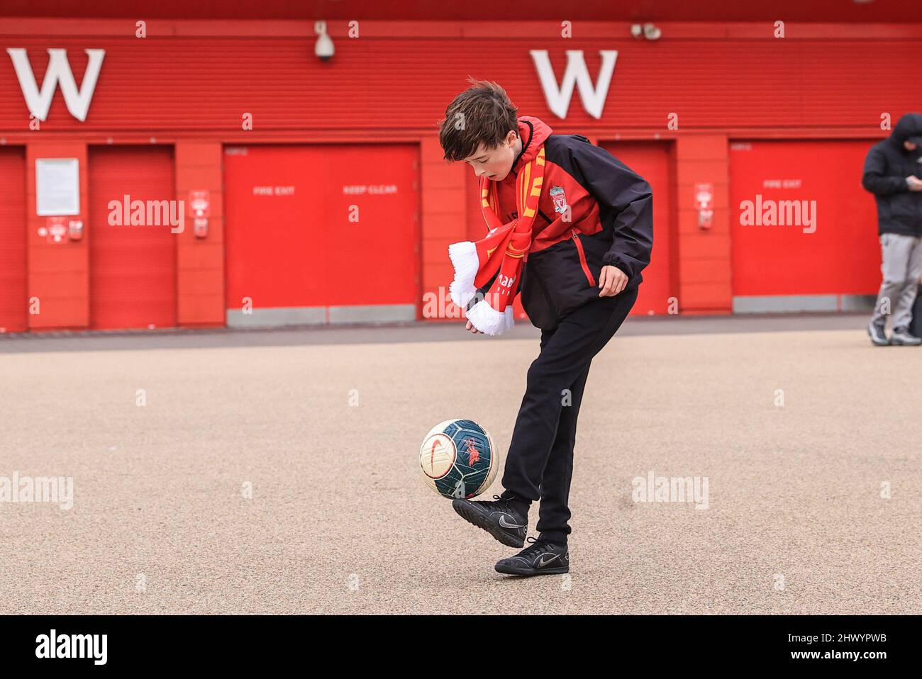A young Liverpool fan doing kick-ups outside Anfield Stock Photo - Alamy