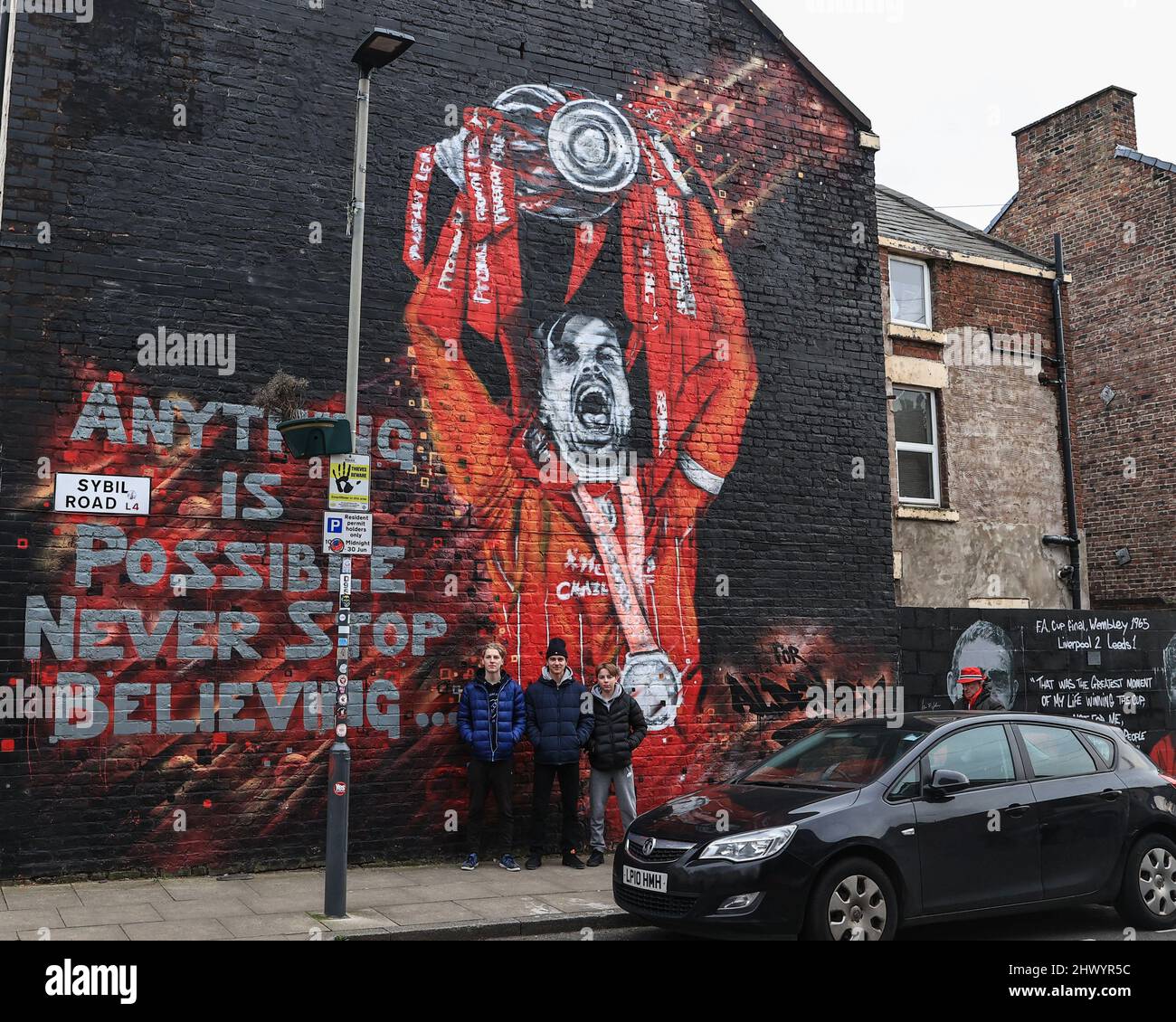 Liverpool, UK. 08th Mar, 2022. Fans check out the mural on Sybil Road ...