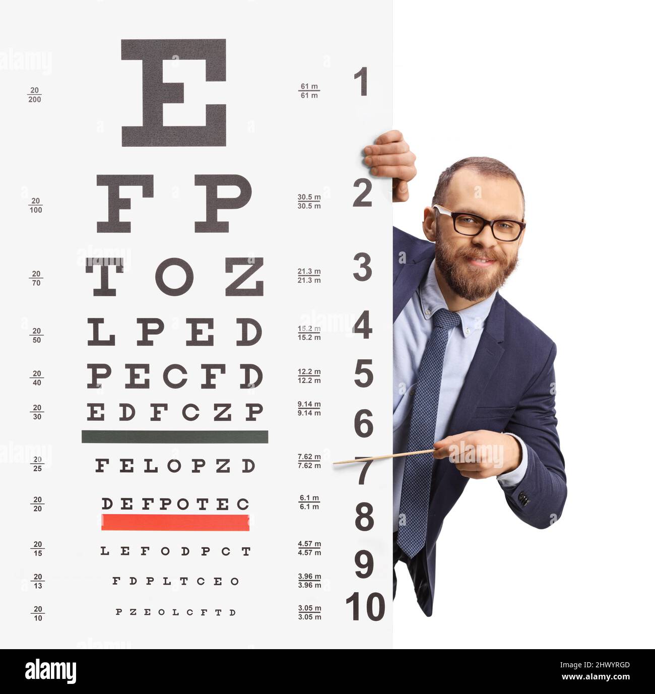 Young man with glasses behind an eye vision examination and pointing ...