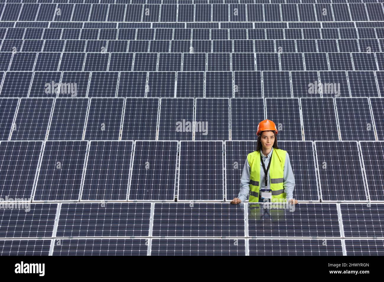 Young female engineer between panels on a photovoltaic solar station ...