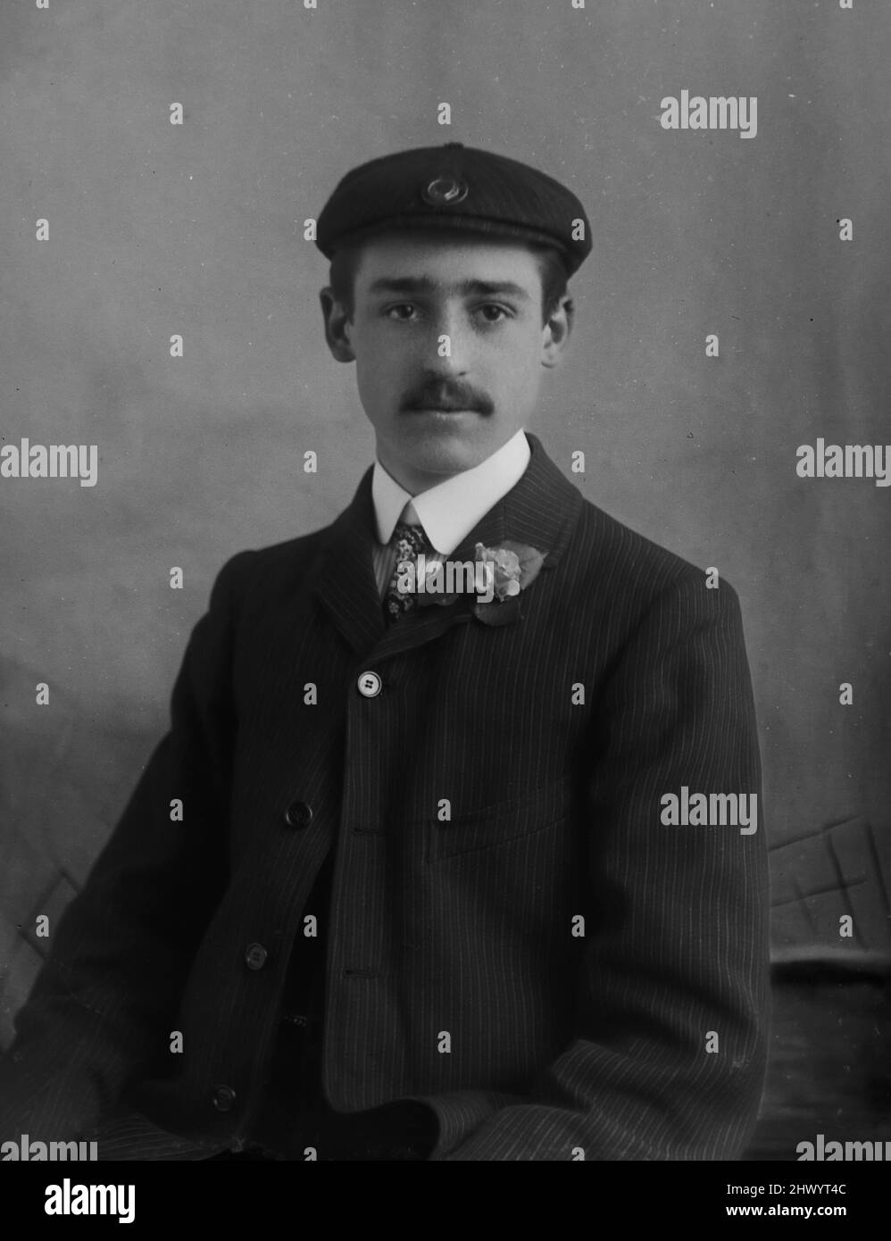 Edwardian formal studio portrait of a man in a dark suit and hat. Taken ...